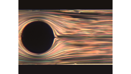 Hydrodynamic cavitation of nematic liquid crystal in Stokes flow behind ...