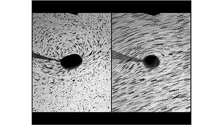 Motion of a floating sphere pulled by a string and induced flows ...